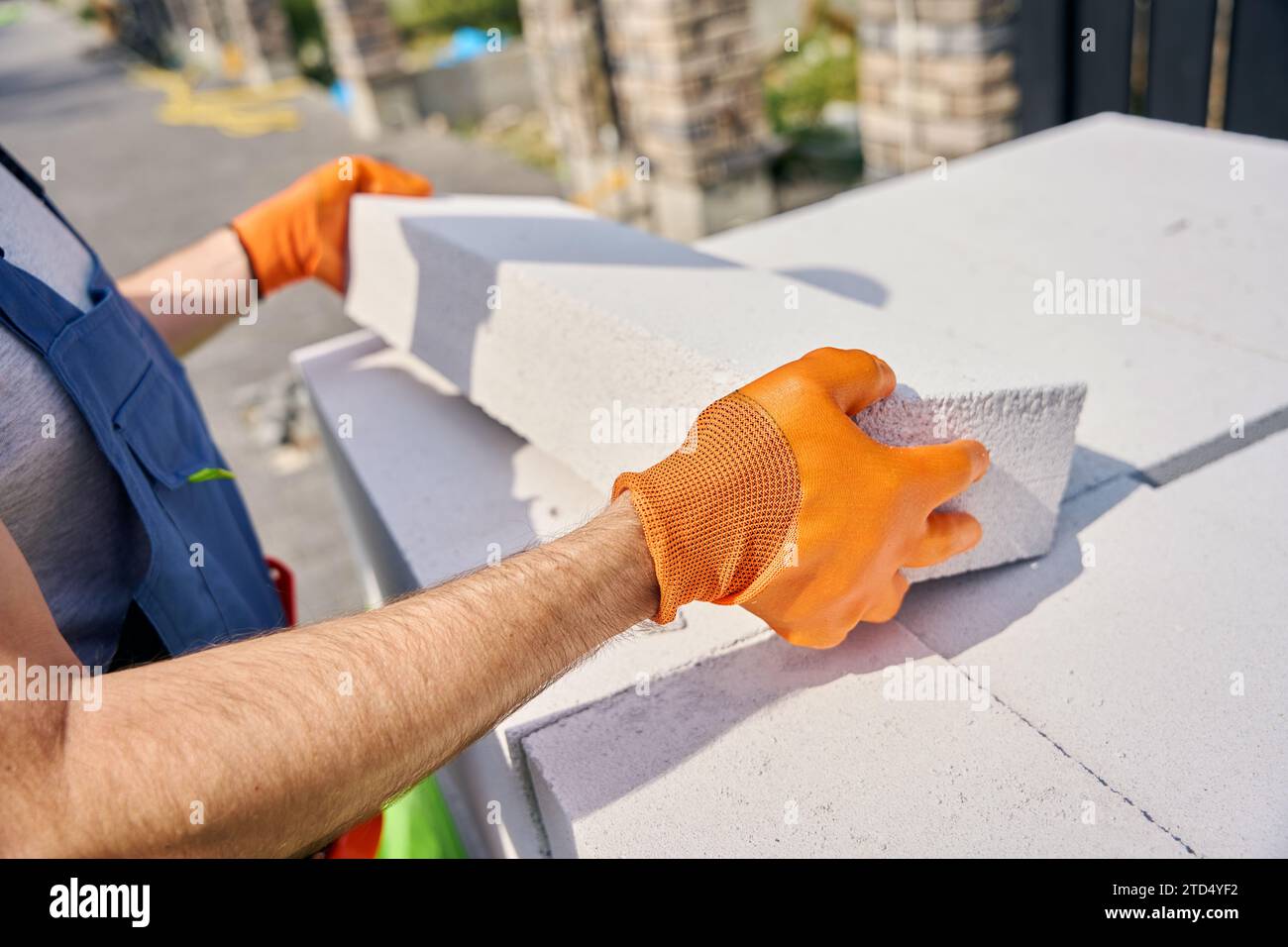 Experienced builder inspecting concrete paving stones on building site ...