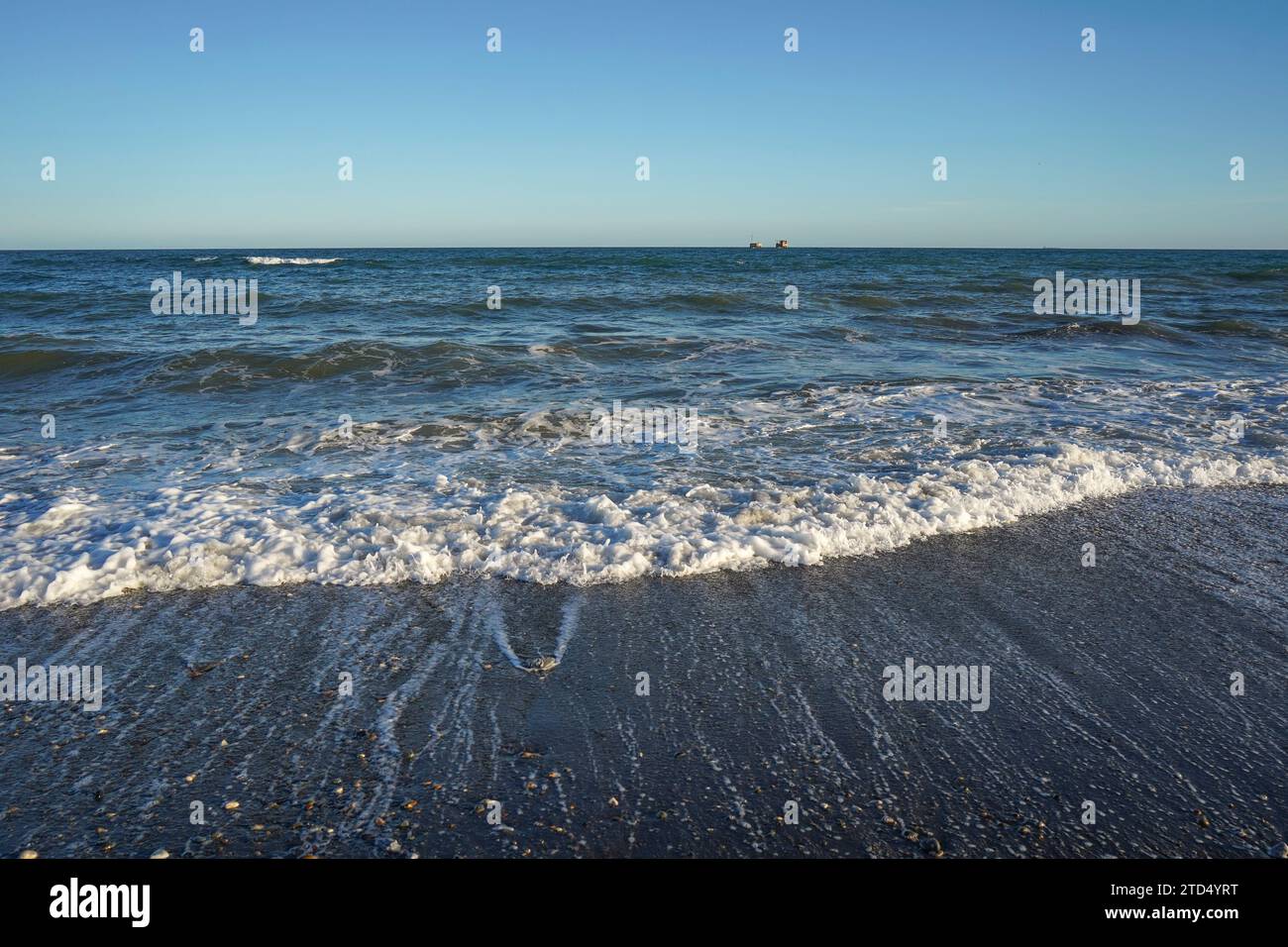 Sea tide wave pulling back at beach. Spain Stock Photo - Alamy