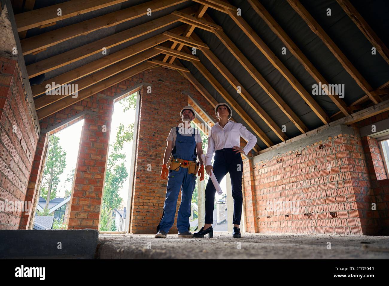 Construction inspector and contractor performing inspection of building ...