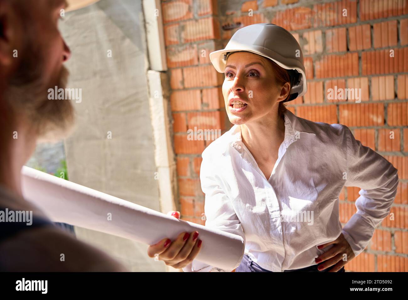 Furious building inspector telling off contractor on site Stock Photo ...