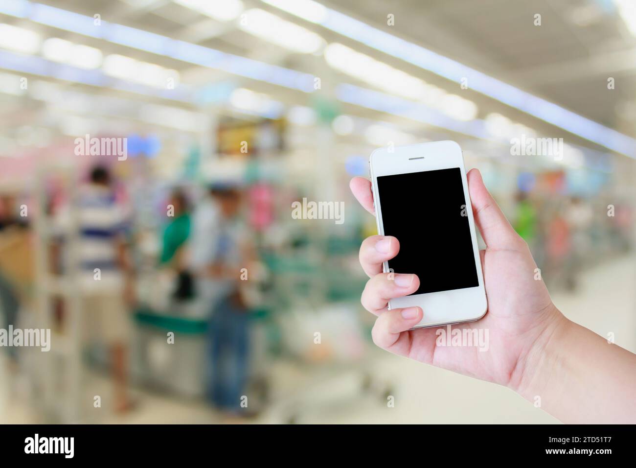 Hand use smartphone with Supermarket store background ,Cashier counter ...