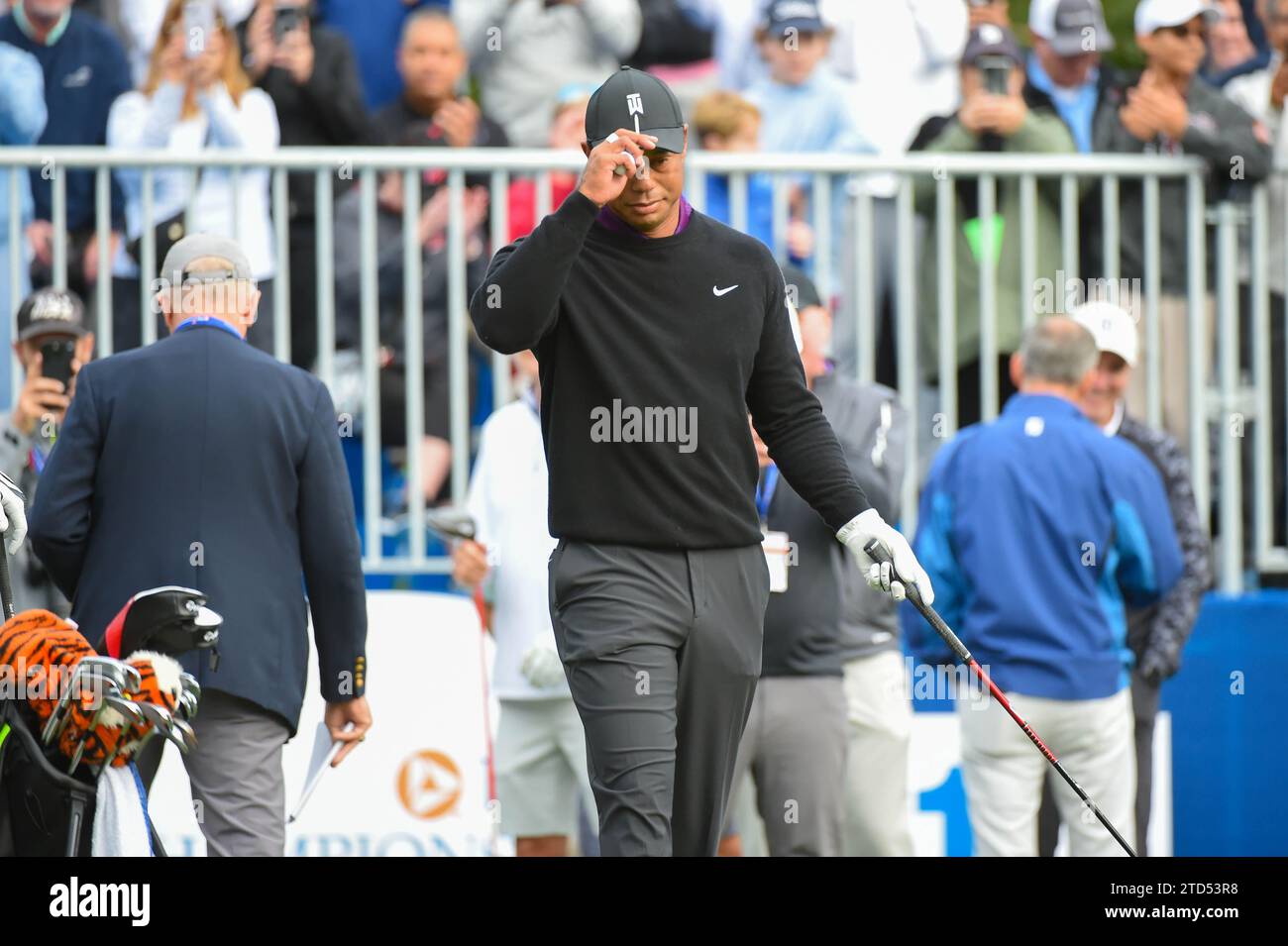 ORLANDO, FL - Tiger Woods tips his cap to fans before he tees off on ...