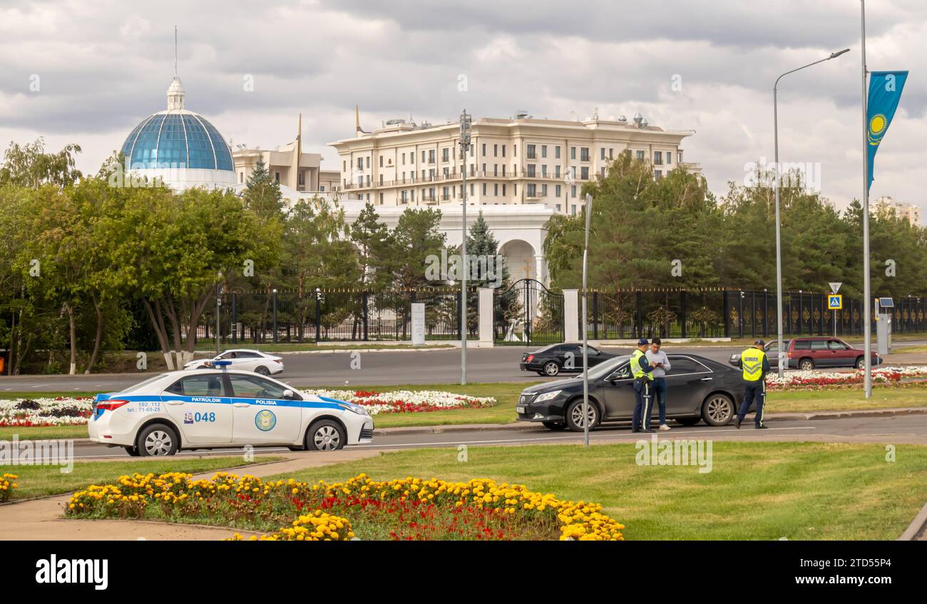 Kazakh traffic police, Kazakh policemen beside polisia patrol vehicle ...