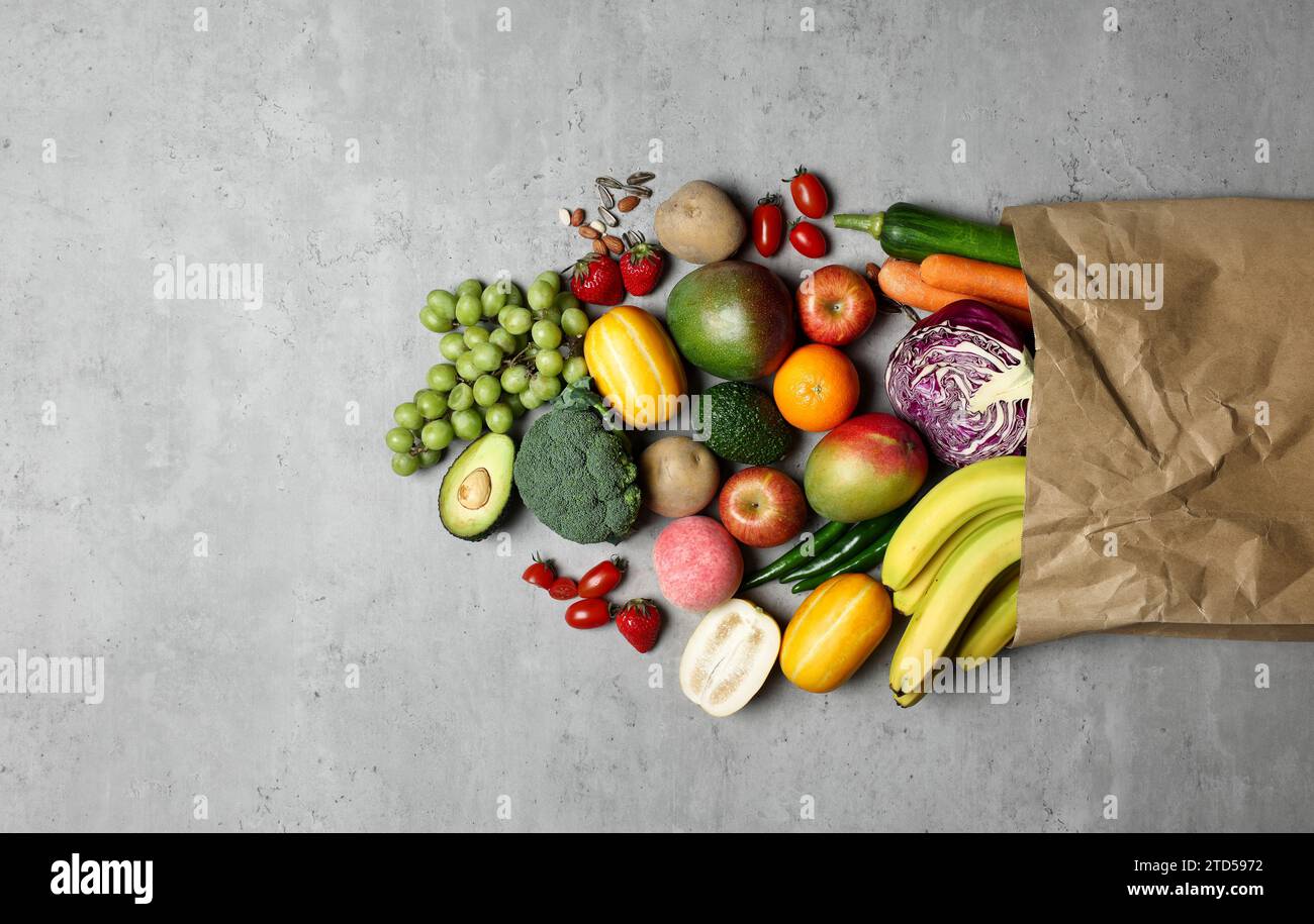 Paper shopping bag, ingredients pouring out Stock Photo - Alamy