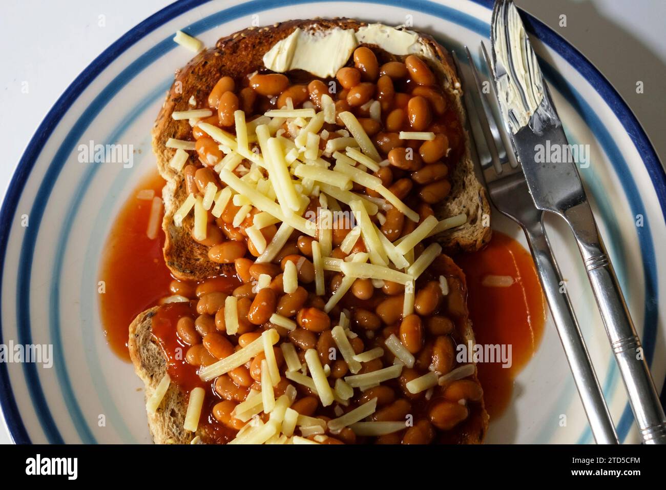 Beans on toast with cheese. Somple food Stock Photo - Alamy