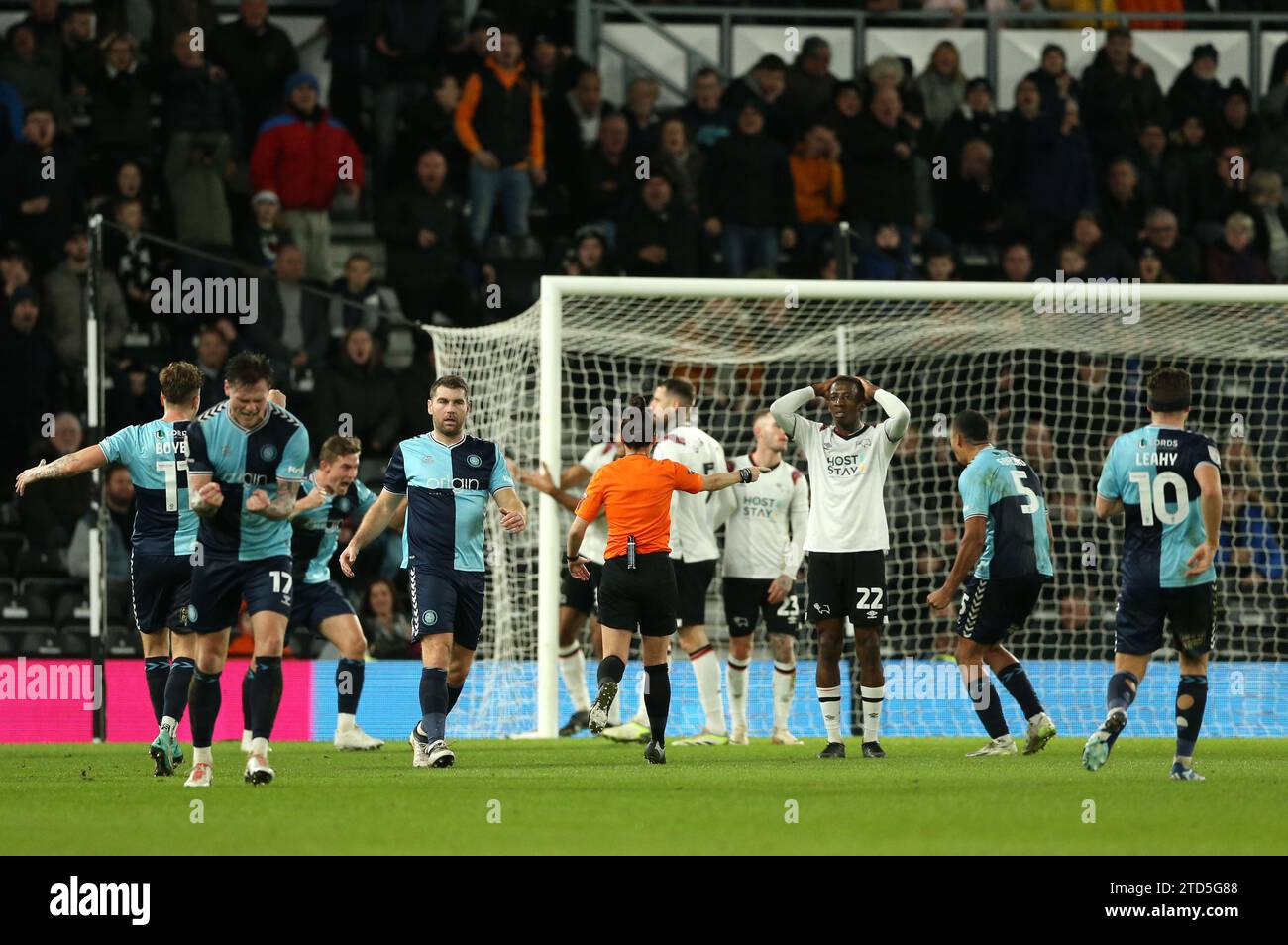 Players reacts after referee Rebecca Welch awards Wycombe Wanderers a penalty during the Sky Bet ...