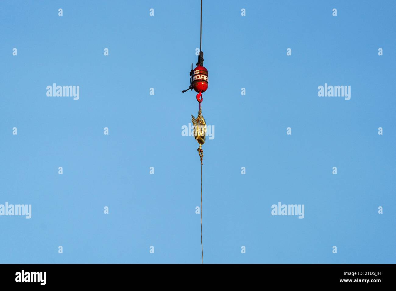 The new golden rooster containing relics is lifted by crane to be ...