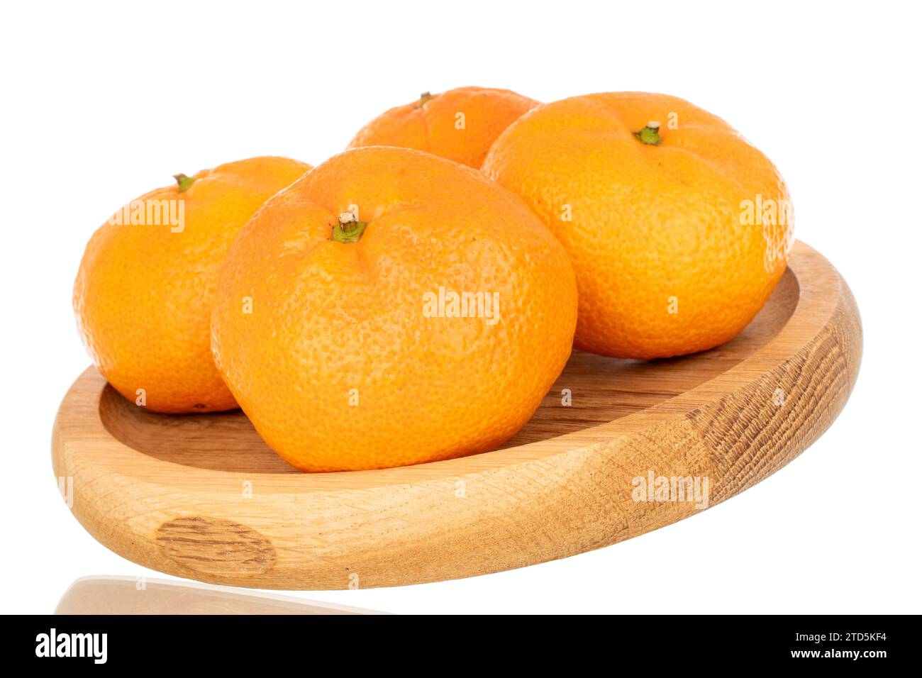 Several juicy sweet tangerines on a wooden tray, macro, isolated on ...