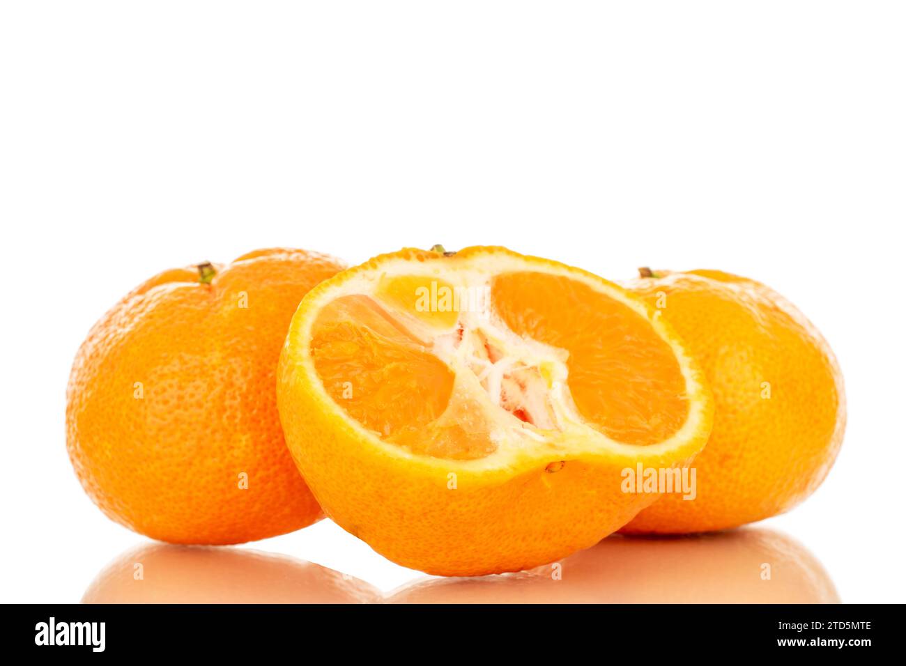 One half and two whole juicy fresh tangerines, macro, isolated on white ...