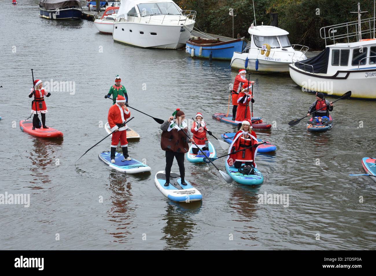 Paddle boarders dressed as Santa and Elves. Christmas paddle boarding ...