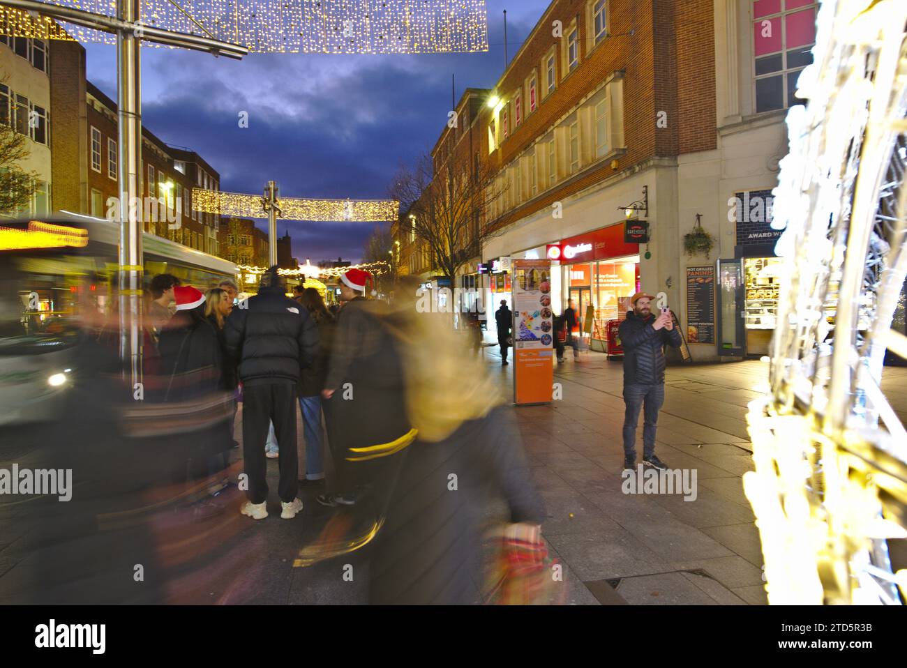 People in Exeter city centre enjoy the festive lights and decorations ...