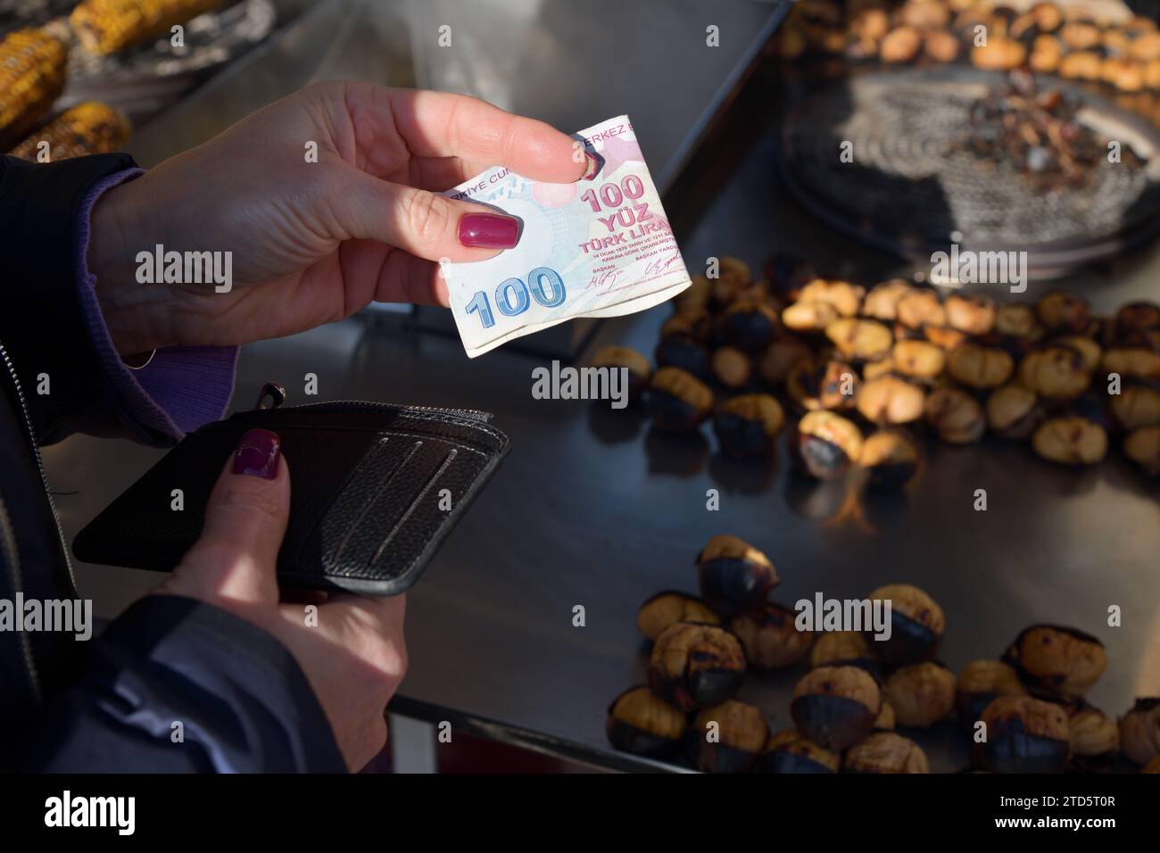 Istanbul, Turkey - December 10, 2023: A woman buys street food in ...