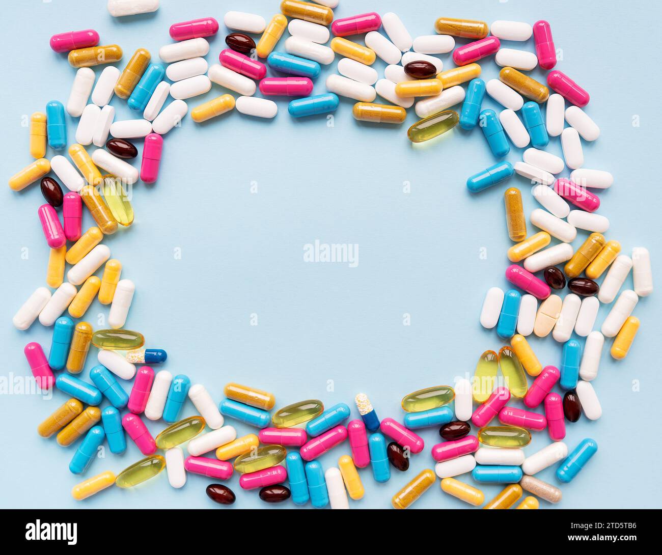 The image shows an assortment of colorful tablets and capsules arranged ...
