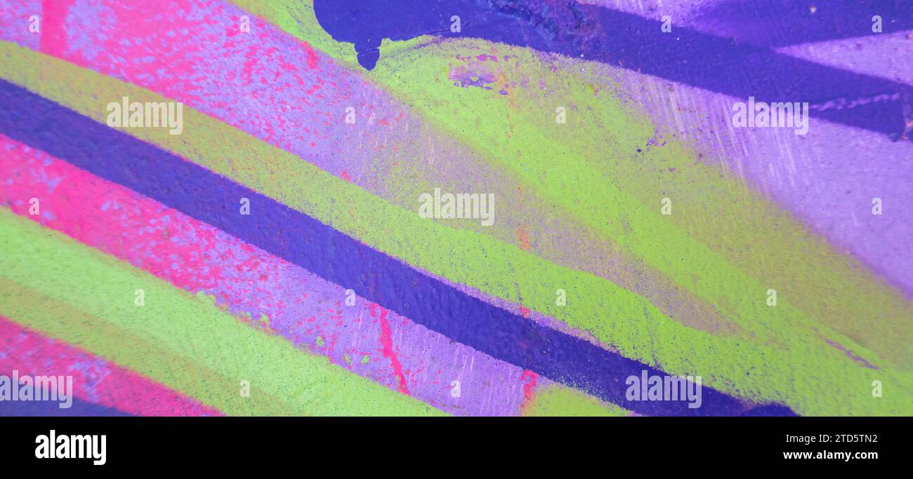 Messy paint strokes and smudges on an old painted wall. Pink, purple ...