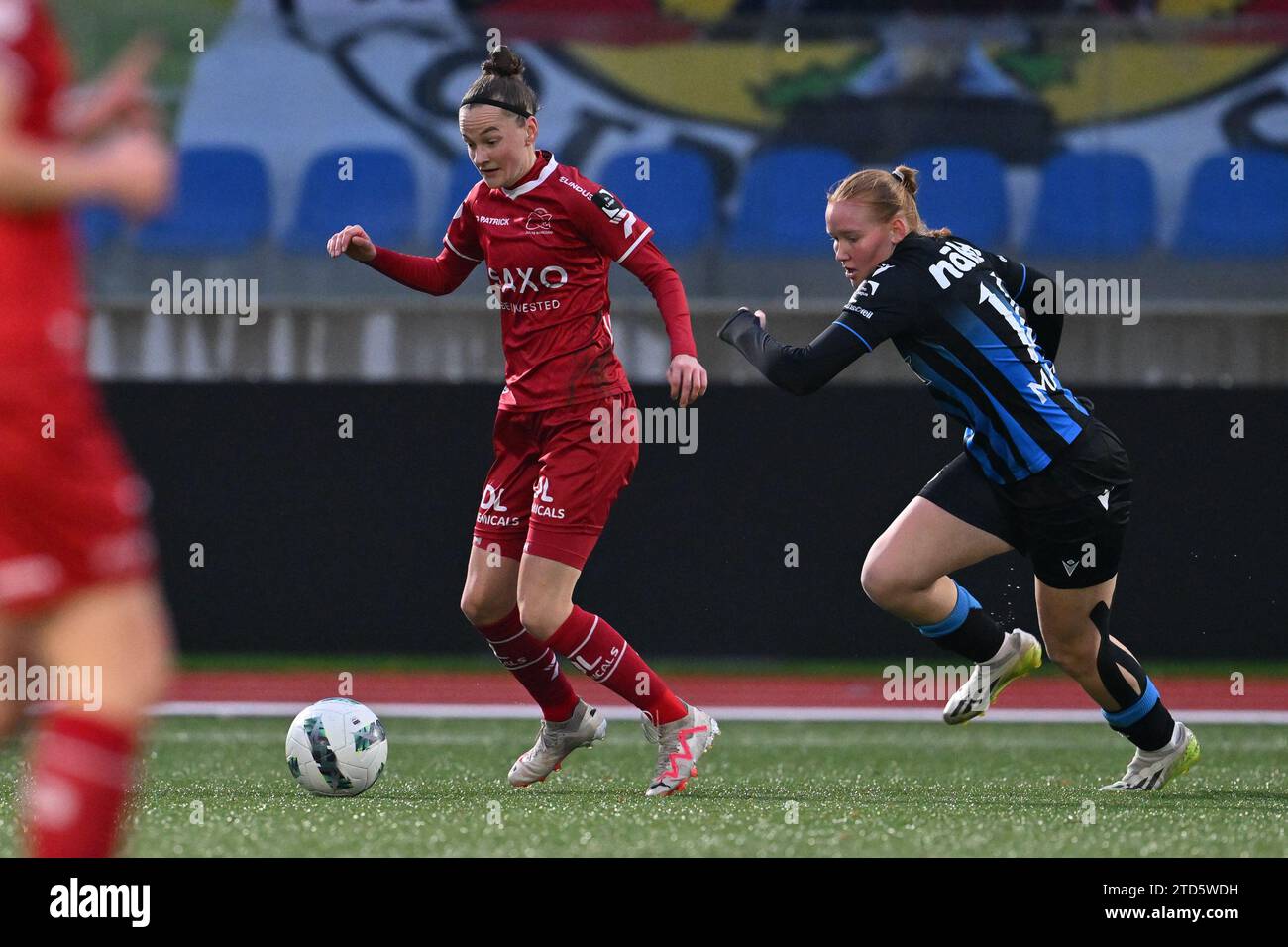 Elke Van Gorp (14) of Zulte-Waregem pictured in a duel with Margaux Martle (16) of Club YLA ...