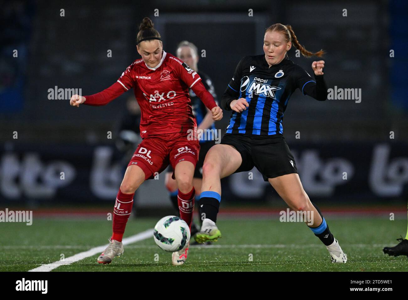 Elke Van Gorp (14) of Zulte-Waregem pictured fighting for the ball with Margaux Martle (16) of ...