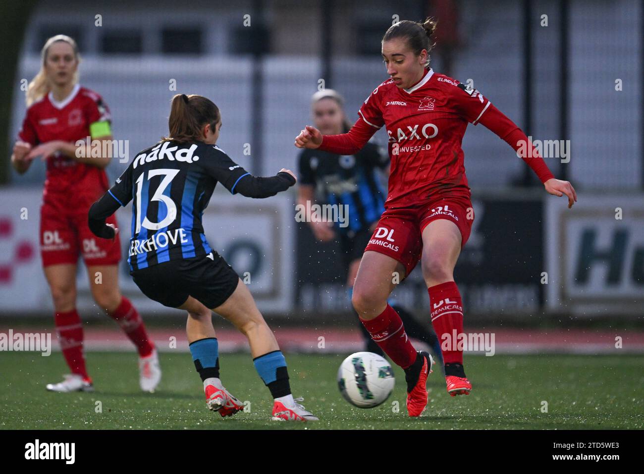 Angel Kerkhove (13) of Club YLA pictured defending on Lena Hubaut (8) of Zulte-Waregem during a ...
