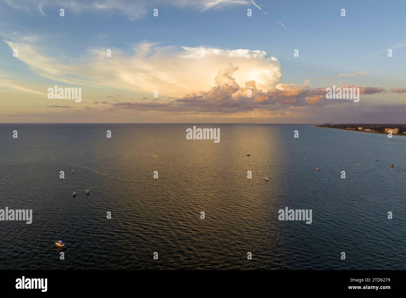 Aerial view of small yachts at sunset floating on sea waves with ripple ...