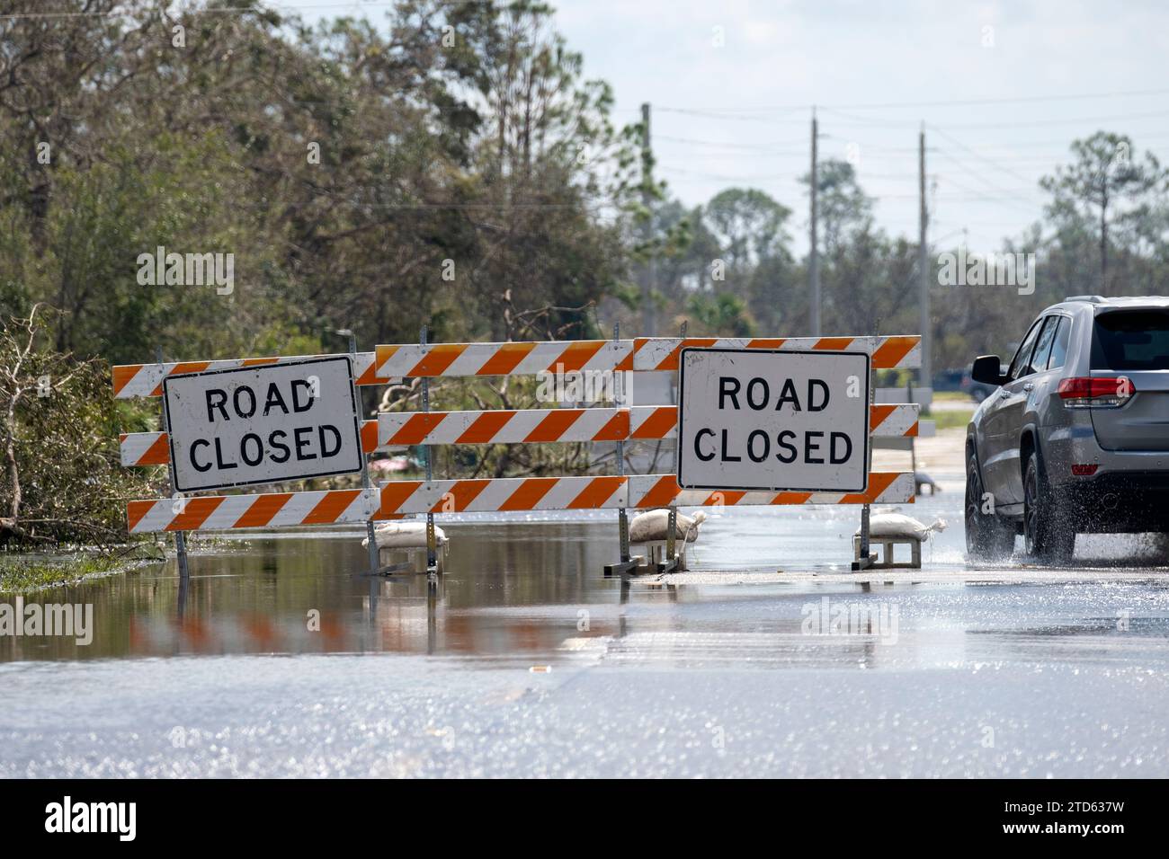 Flooded street in Florida after hurricane rainfall with road closed ...