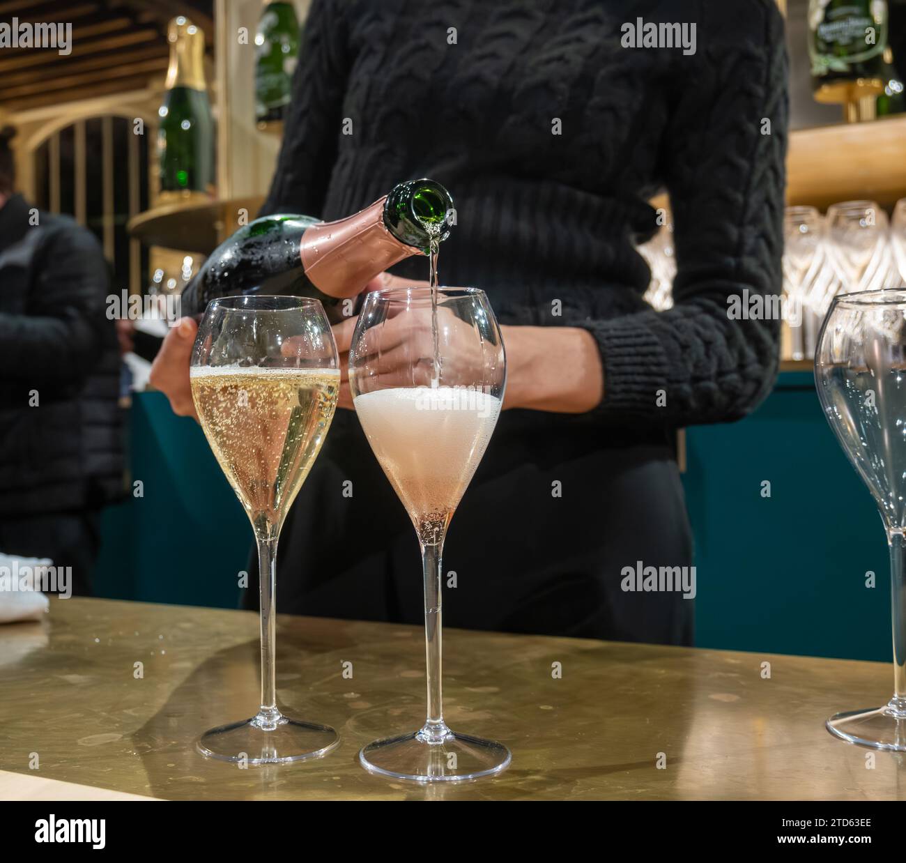 Pouring and tasting of sparkling wine champagne on winter weekend ...