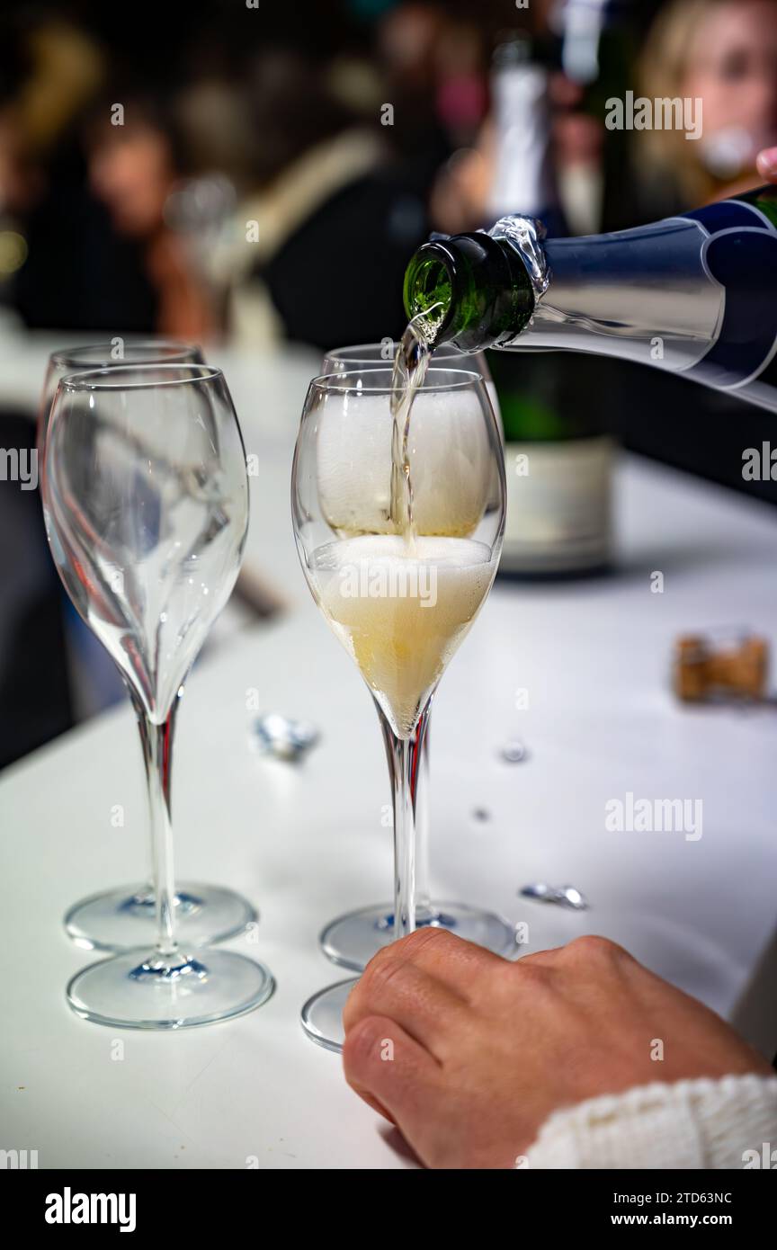 Visitors drinking of sparkling wine champagne on outdoor winter ...