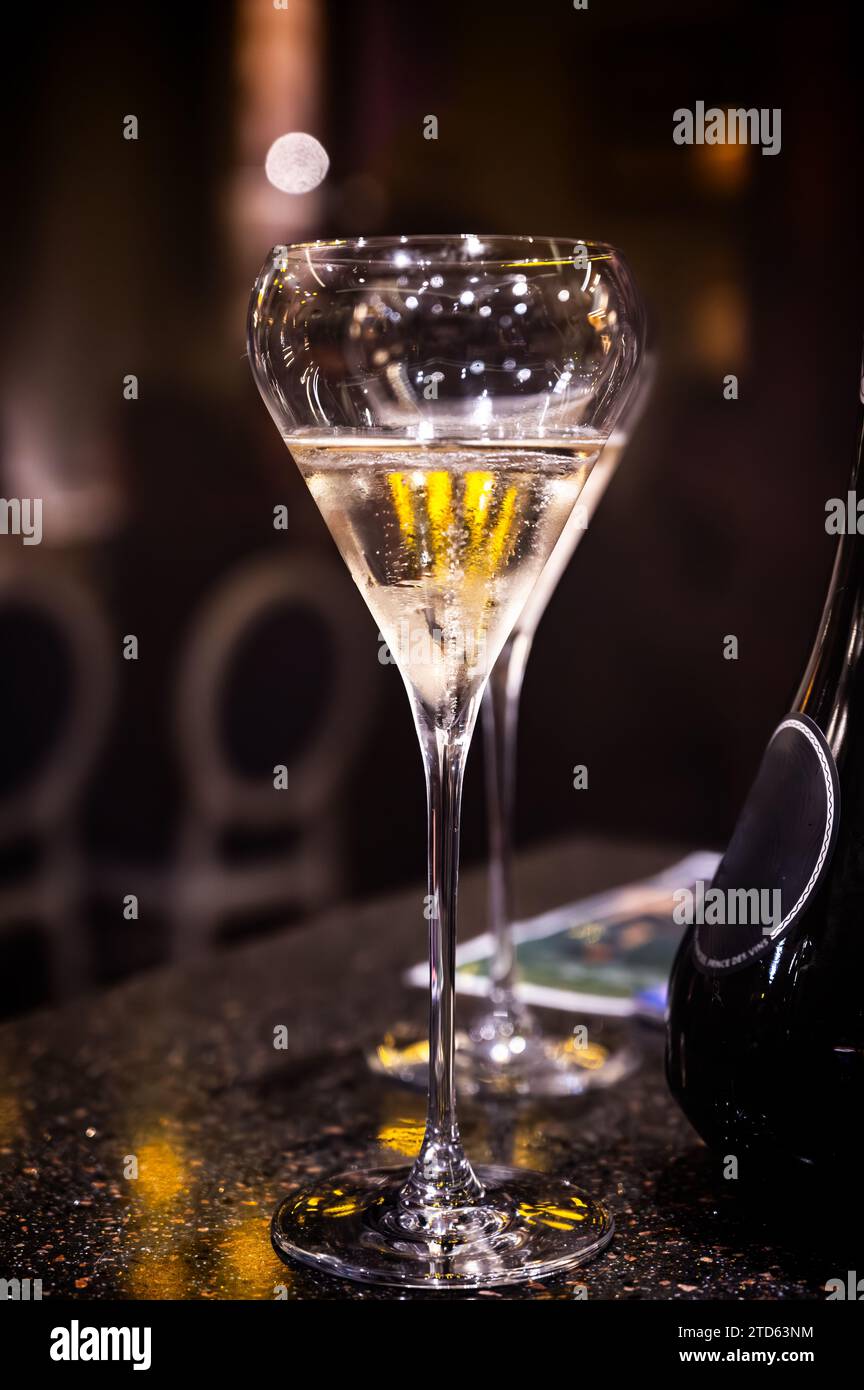 Visitors drinking of sparkling wine champagne on outdoor winter ...