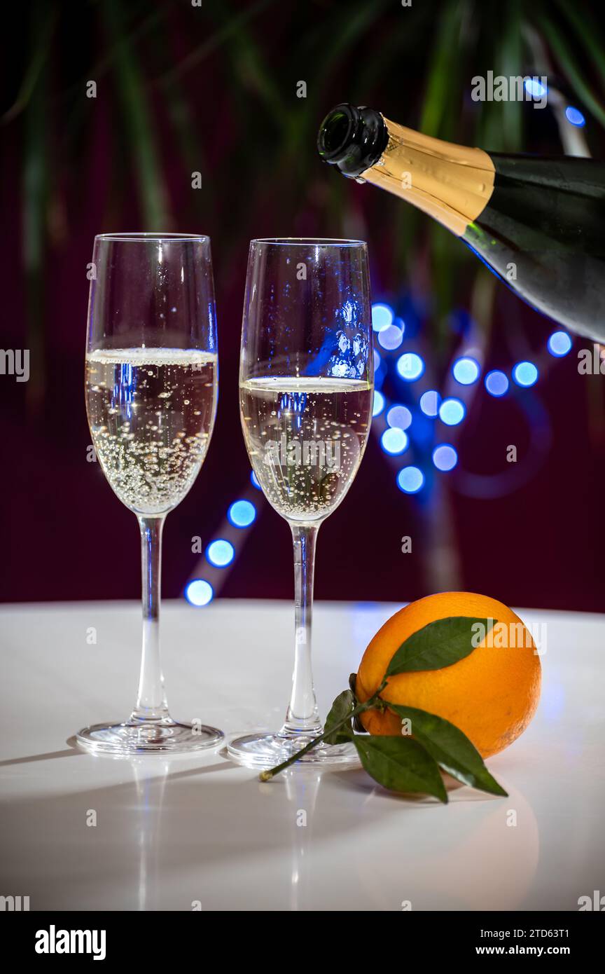 Pouring of brut champagne, cava or prosecco dry wine in glasses with ...