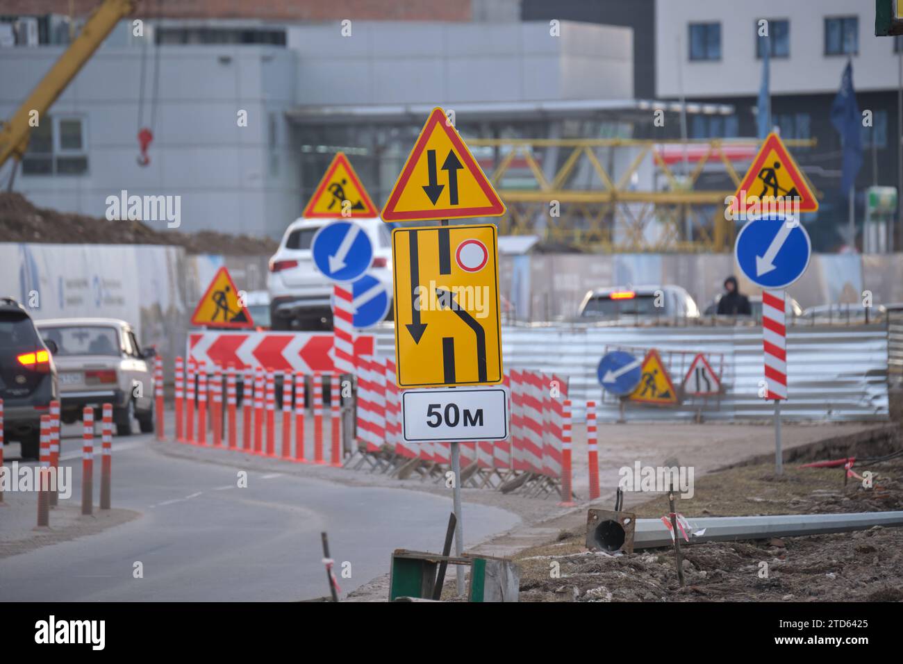 Roadworks warning traffic signs of construction work on city street and ...