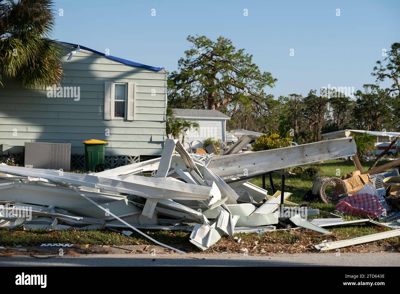 Scrap metal disposed in heaps on street side after hurricane severely ...