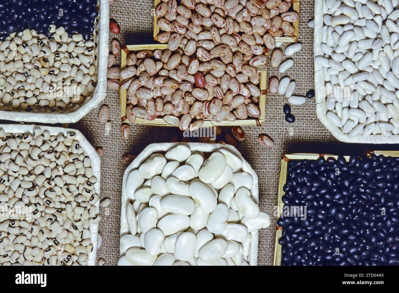 some varieties of beans contained in small baskets Stock Photo - Alamy