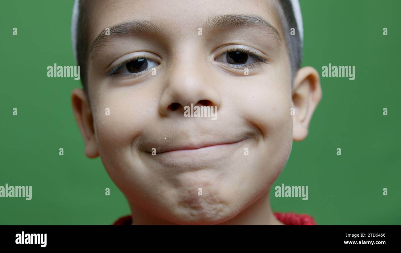 Portrait of cute caucasian boy isolated on green background. High ...