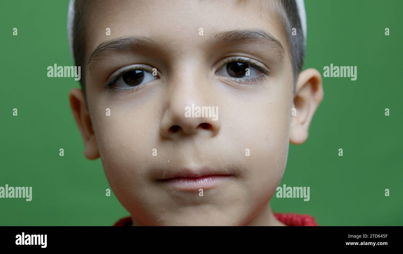 Portrait of cute caucasian boy isolated on green background. High ...