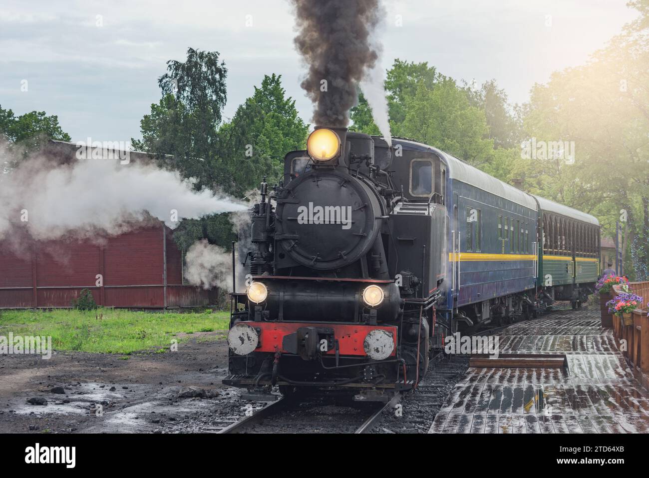 Retro steam train approaches to the platform at early morning Stock ...
