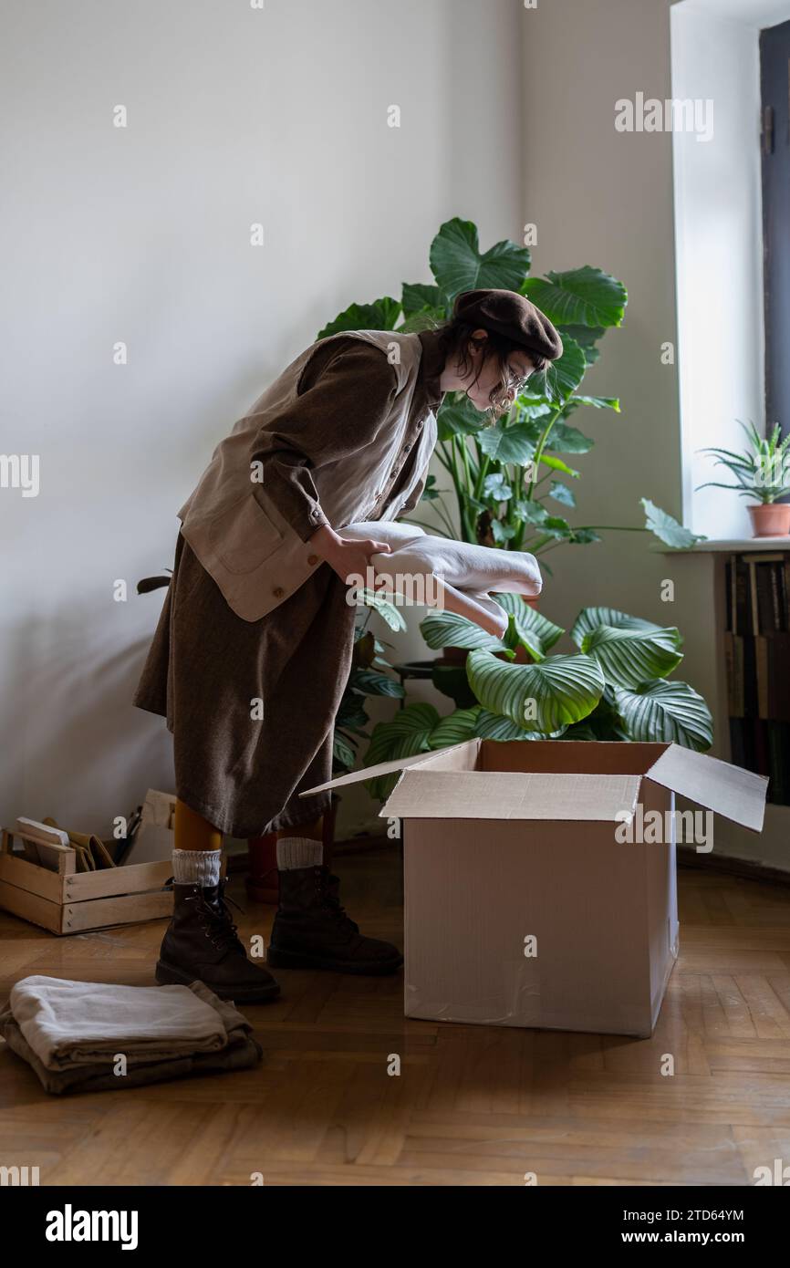 Strong willed girl volunteer collecting things clothes for recycling ...
