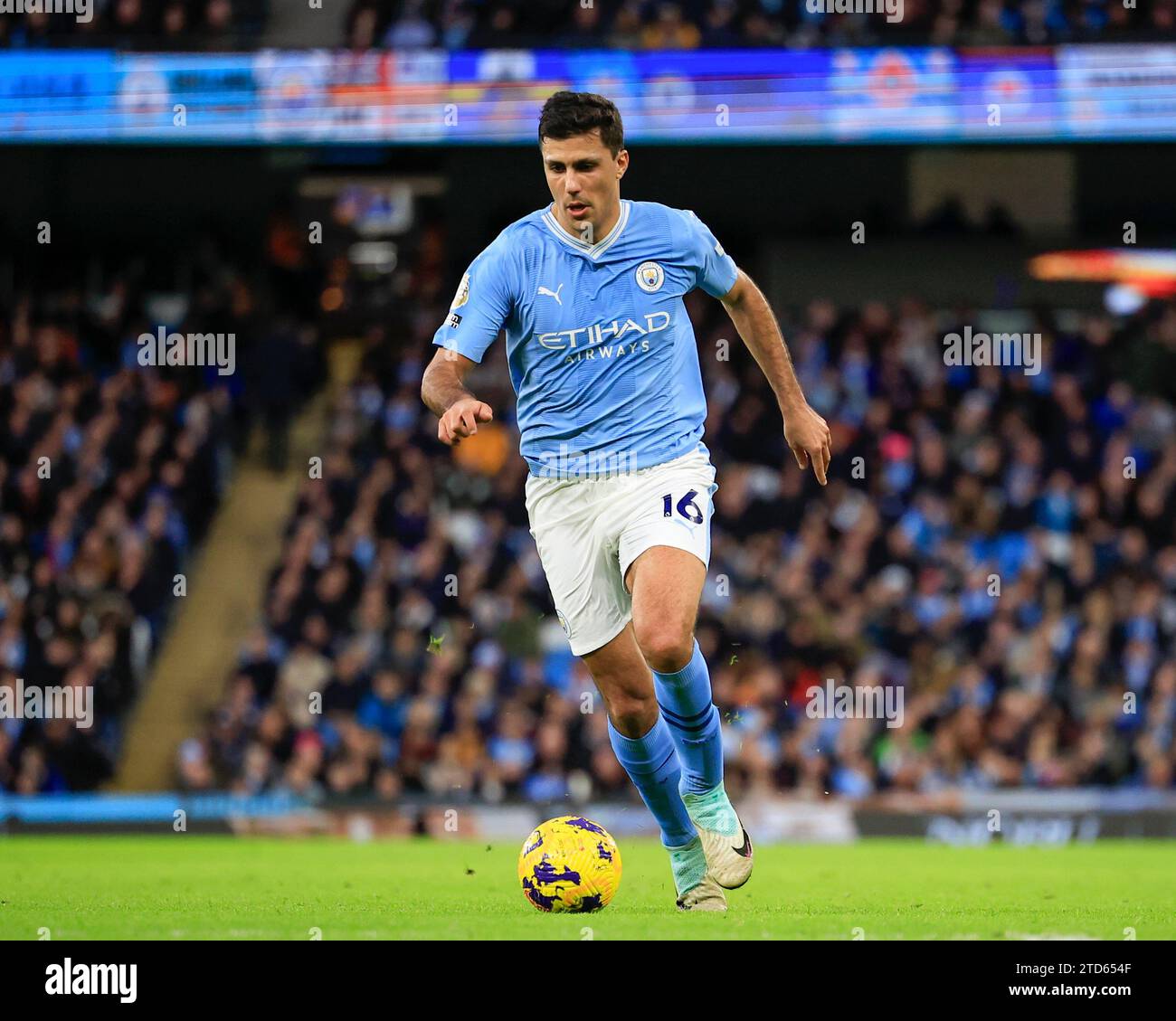 Rodrigo #16 of Manchester City runs with the ball during the Premier ...