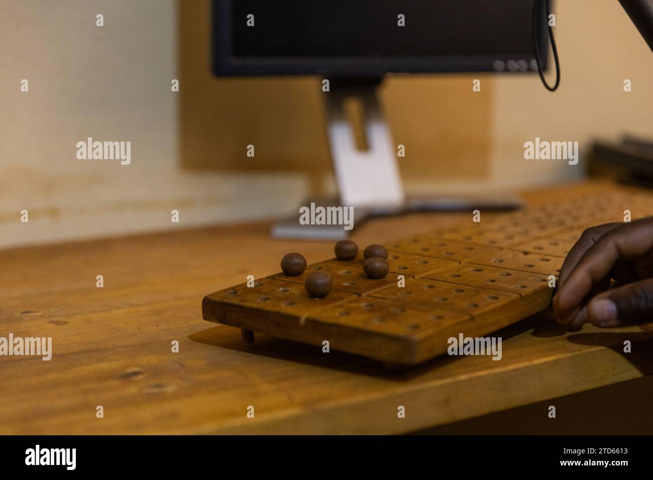 Hand of a blind African person resting on the table next to the braille ...