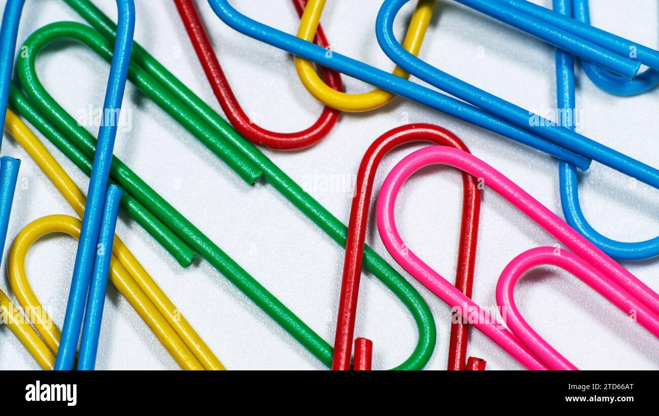 Closeup of assorted colorful paperclips isolated on white background ...