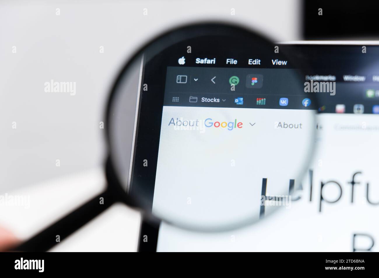 About Google logo on the screen of laptop through magnifying glass ...