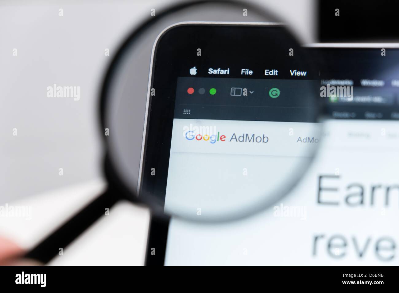 Google AdMob enlarged through a magnifying glass on a laptop screen ...