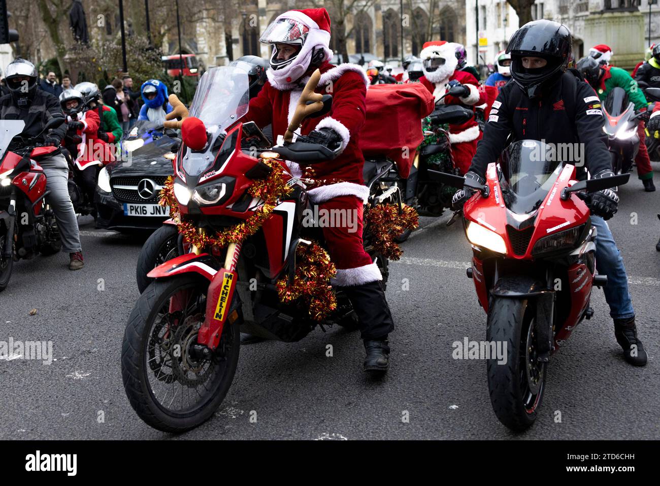 Participants in Santa costumes seen riding their decorated motorbikes ...