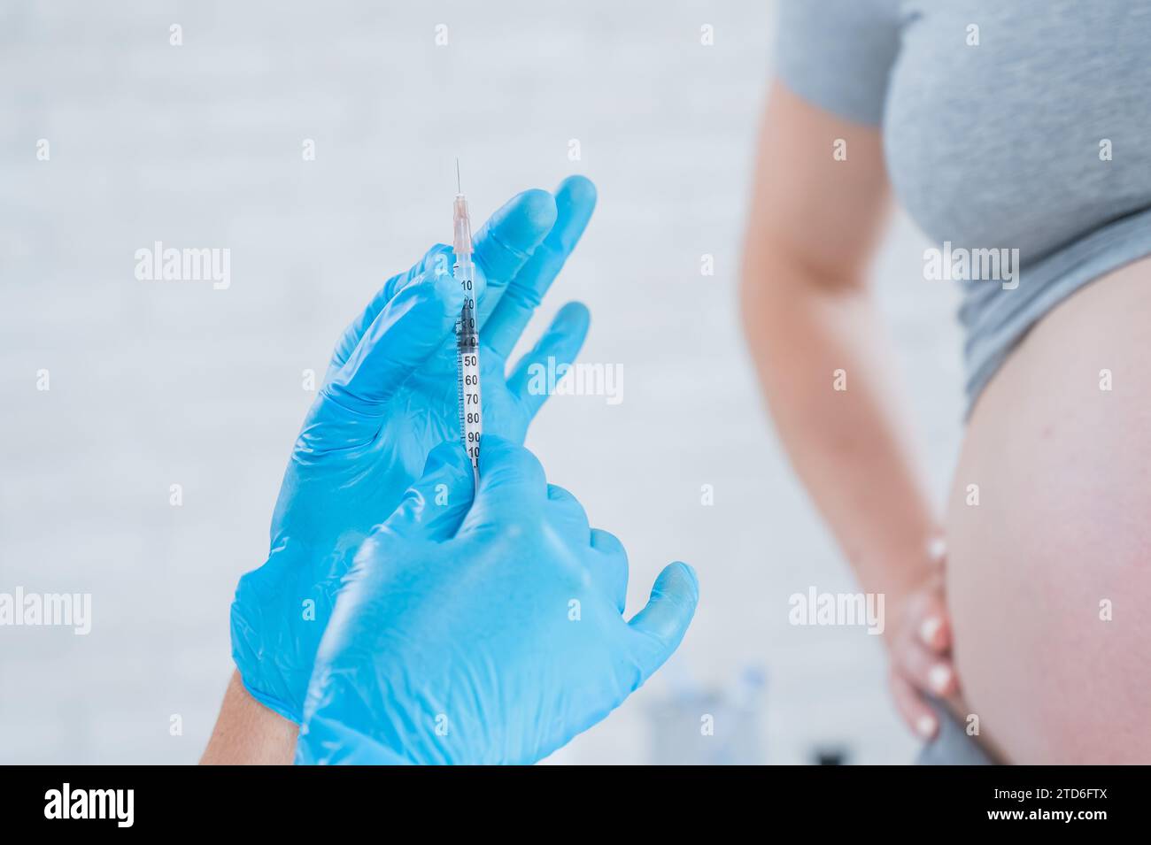 Doctor gives an injection in the stomach of a pregnant woman Stock ...