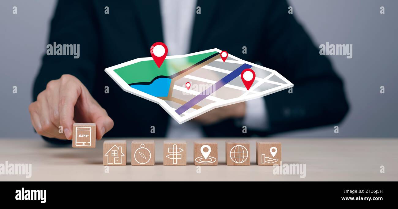 Hand hold wooden block cube and model map with location point , GPS app ... Hand hold wooden block cube and model map with location point , GPS app ...