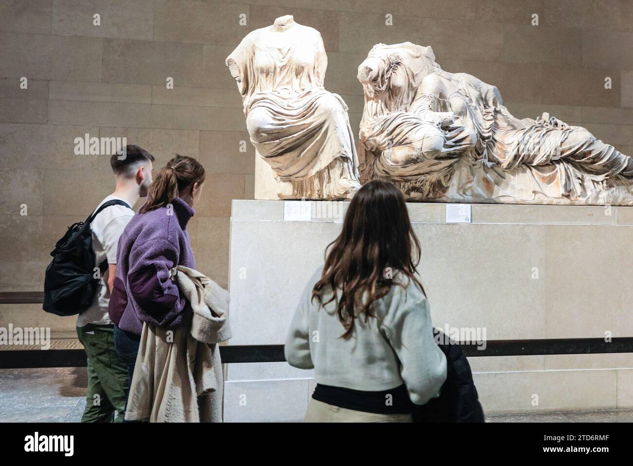 London, UK. 16th Dec, 2023. Tourists and visitors admire sculptures from the east pediment ...