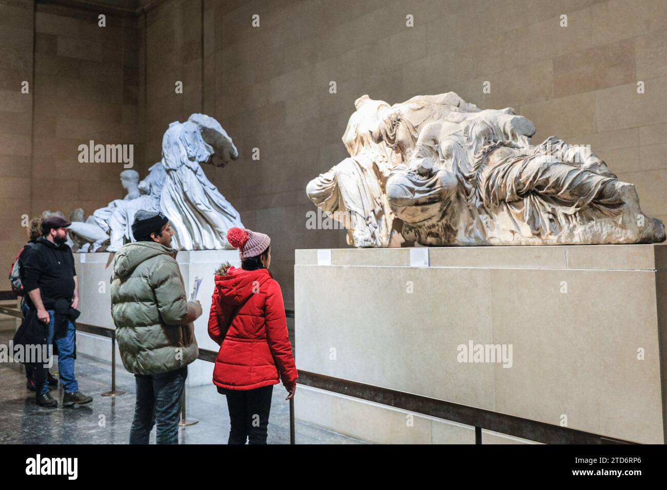 London, UK. 16th Dec, 2023. Tourists and visitors admire sculptures from the east pediment ...