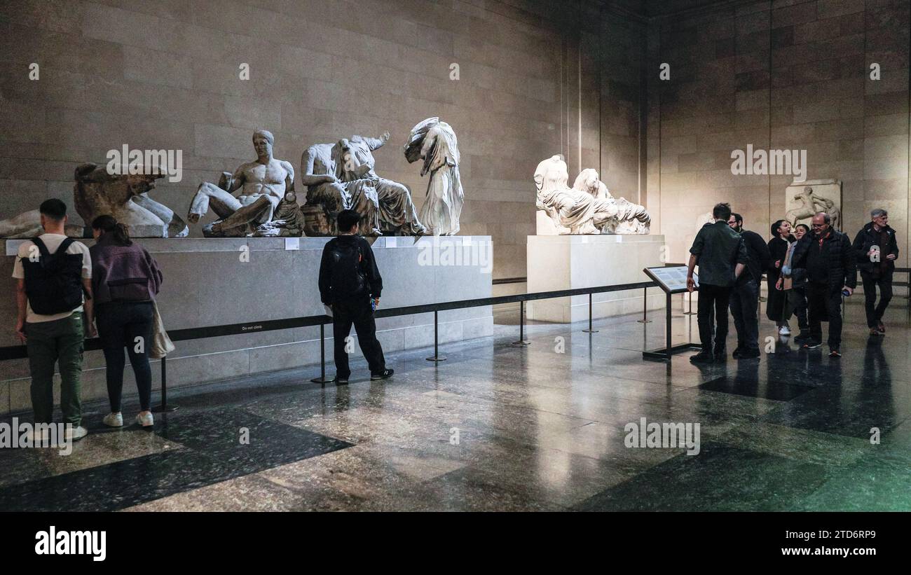 London, UK. 16th Dec, 2023. Tourists and visitors admire sculptures from the east pediment ...