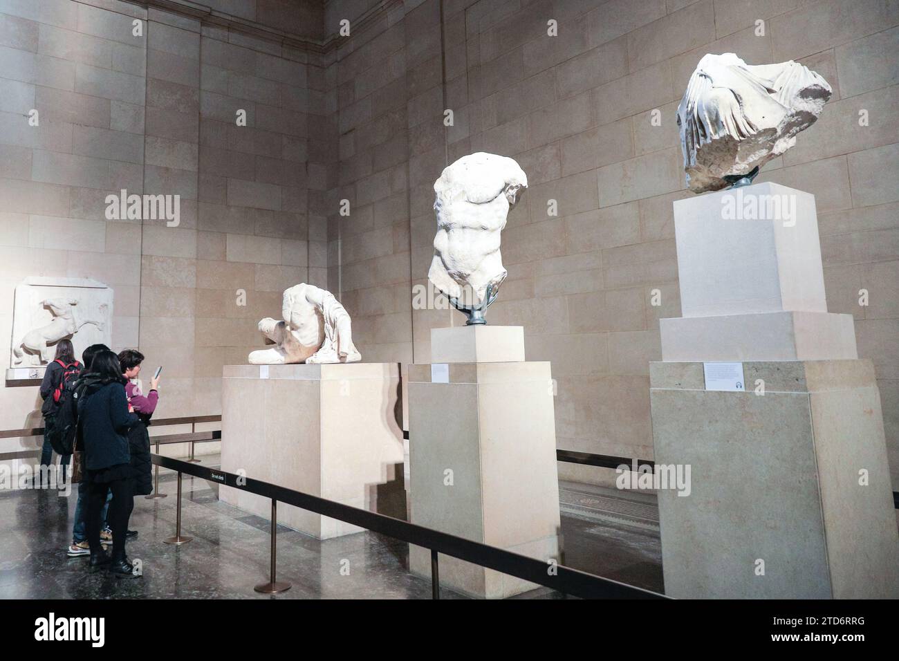 London, UK. 16th Dec, 2023. Tourists and visitors admire sculptures from the west pediment ...