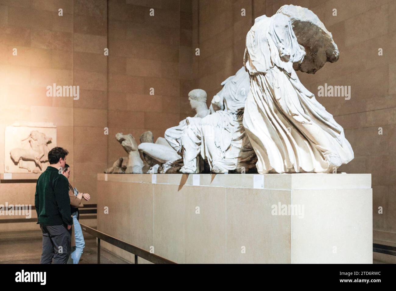London, UK. 16th Dec, 2023. Tourists and visitors admire sculptures from the east pediment ...