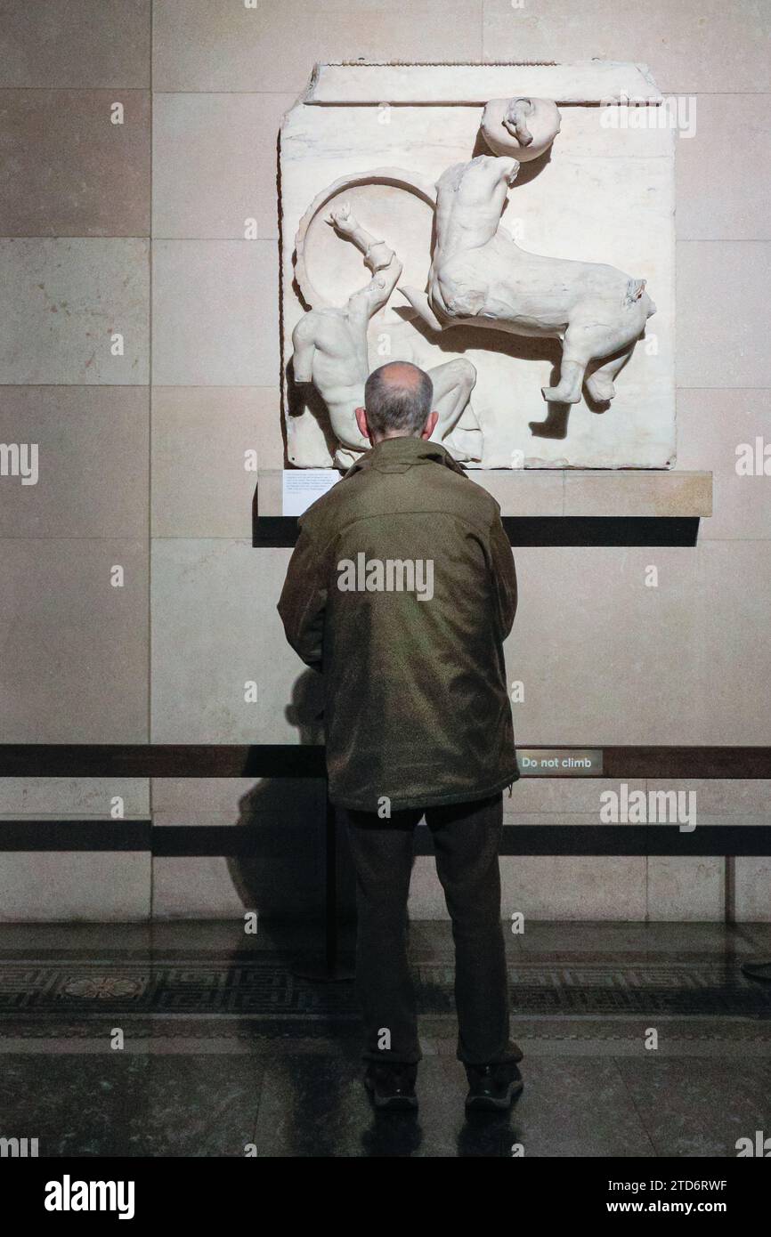 London, UK. 16th Dec, 2023. Tourists and visitors admire sculptures from the west pediment ...