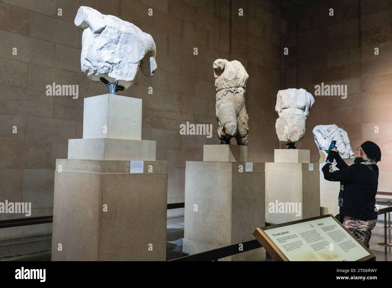 London, UK. 16th Dec, 2023. Tourists and visitors admire sculptures from the west pediment ...