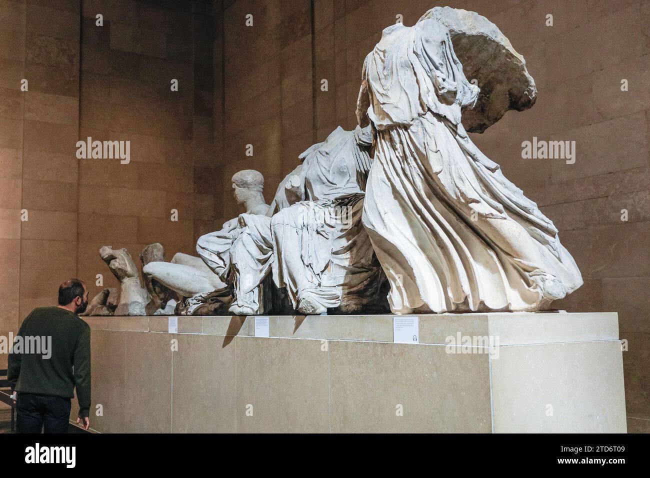 London, UK. 16th Dec, 2023. Tourists and visitors admire sculptures from the east pediment ...